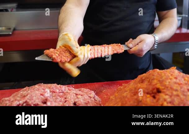Chef shapes raw meat for kebabs in a lively kitchen space Stock Video ...