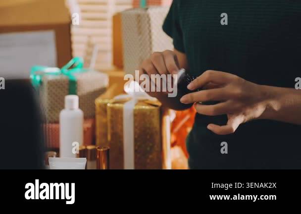 close - up of female hands holding bottle of perfume on blurred ...