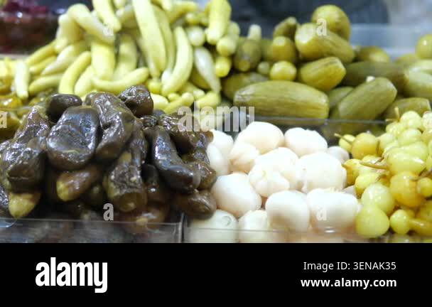 People shop for different pickles and fruits at a local market Stock ...