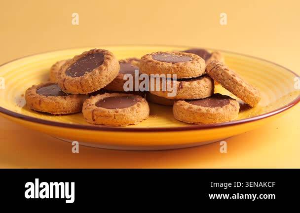 Delicious cookies sit on a plate against a yellow background Stock ...
