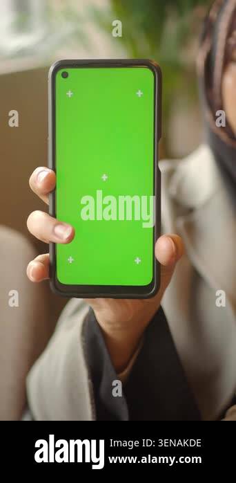 Individual shows a smartphone with a green screen in a cafe Stock Video ...