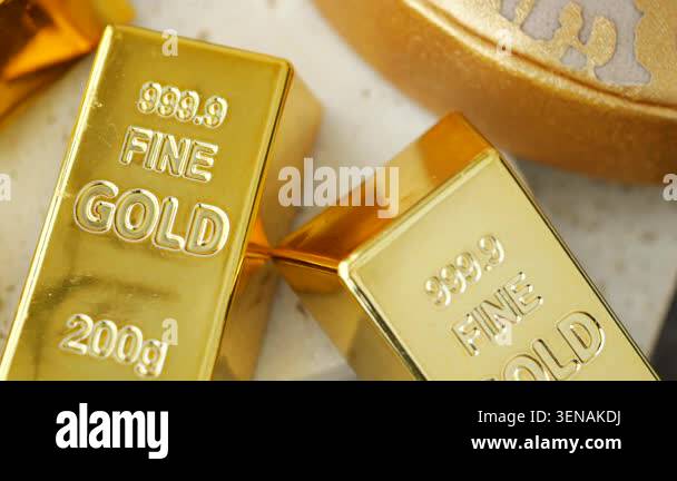 Two gold bars labeled fine gold resting on a table in a shop Stock ...