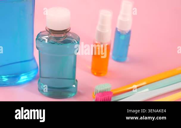 Different oral care items are shown on a pink background for daily use ...