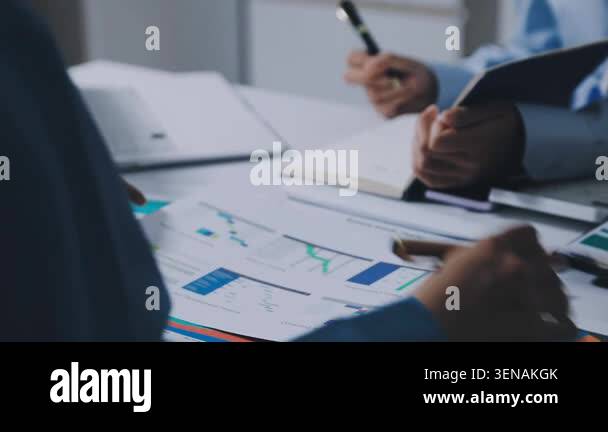 young businessman analyzing financial charts with his colleagues in ...