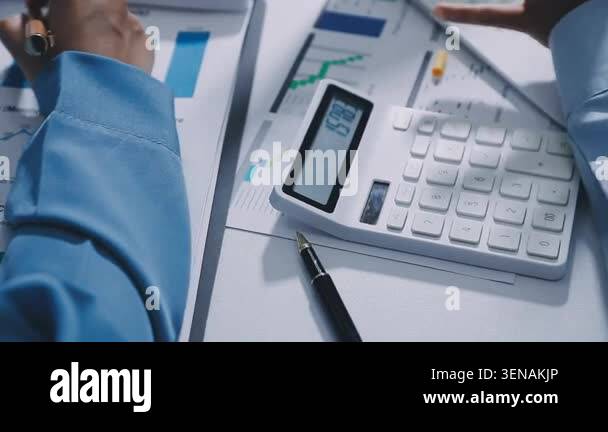 close up of businessman hand writing on calculator in office Stock ...