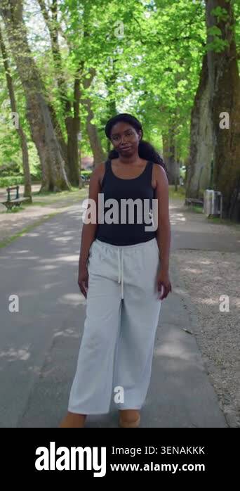 Young African American Woman smiling naturally in park environment ...