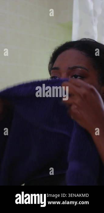 Young African American Woman maintaining daily skincare regimen through ...