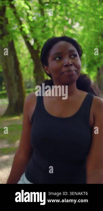 Young African American Woman enjoying quiet walk in natural green ...