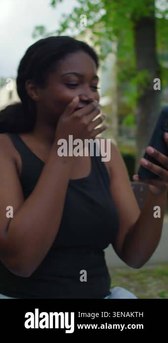 Young African American Woman covering mouth in shock while looking at ...