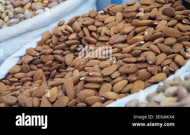 People explore a local market to find fresh almonds and nuts Stock ...