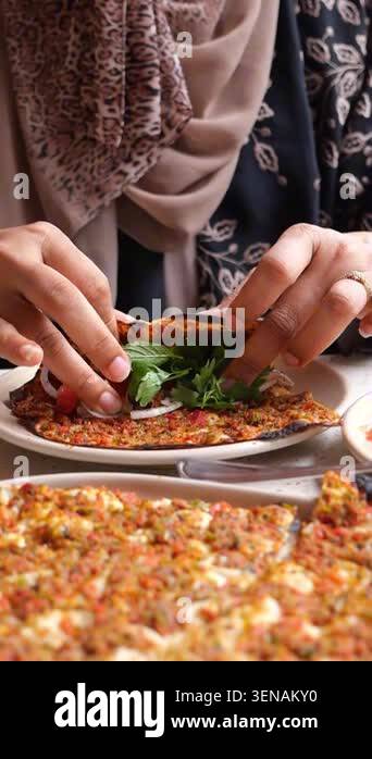Enjoying Lahmacun, a thin Turkish flatbread topped with minced meat ...