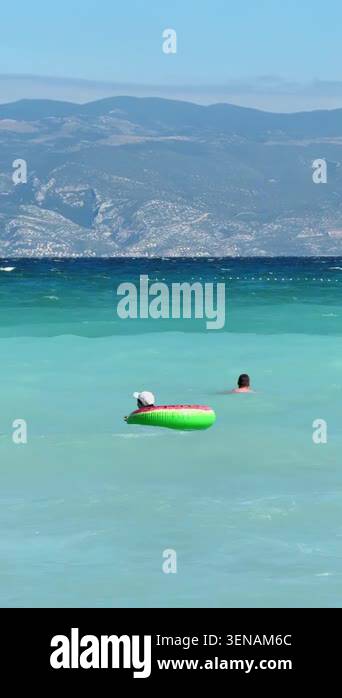 Woman floating on inflatable ring in turquoise sea croatia krk Stock ...