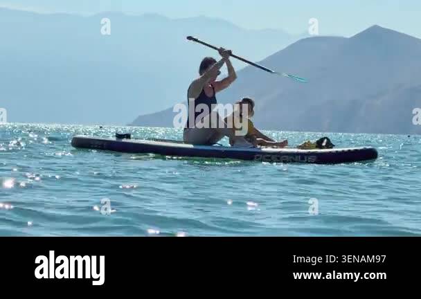 Mother and child paddling on mountain lake Croatia Krk Stock Video ...
