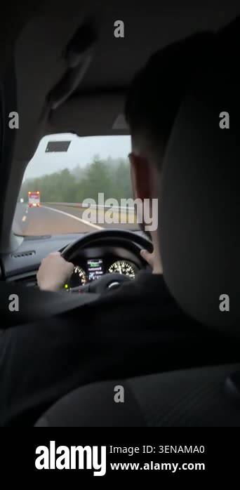 Man driving car on country road seen from back seat Stock Video Footage ...