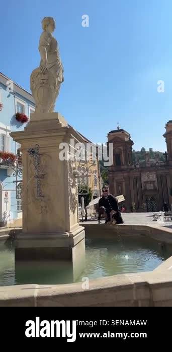 Stone statue fountain in a sunny historic town square Mikulov Czech ...