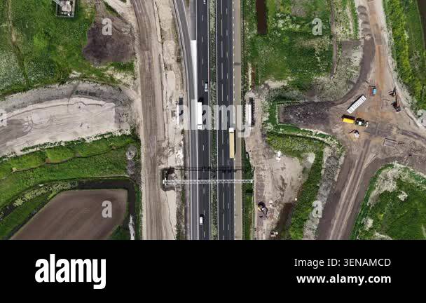 Top down aerial perspective of a multi lane highway with cars and ...