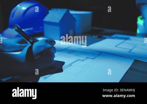 close up view of engineer hands working on project with blueprint in ...