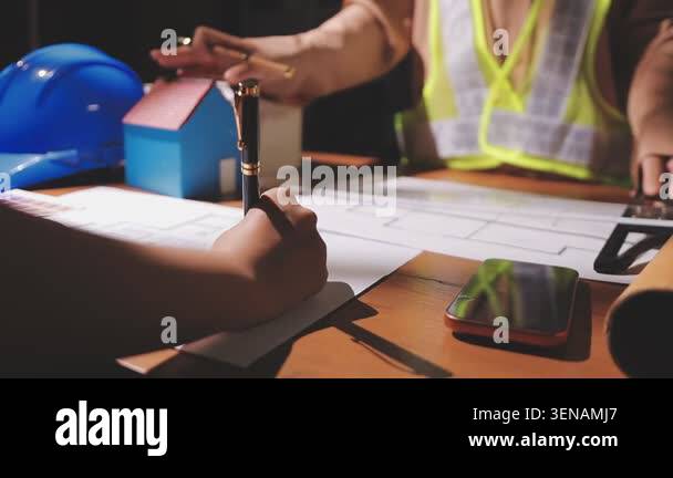 architect engineer working on blueprint and drawing a blueprint in the ...
