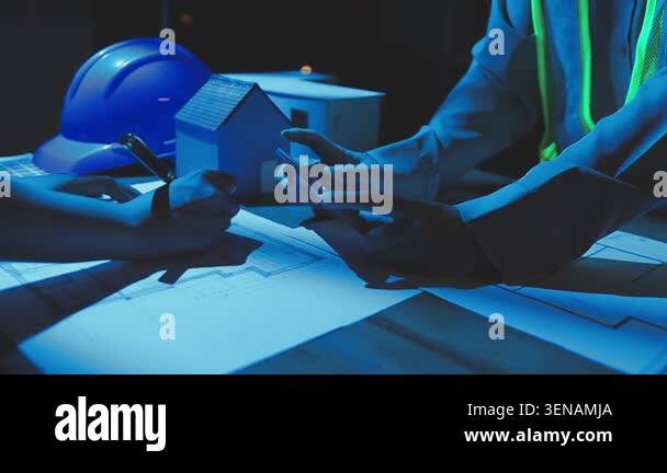 engineer engineer working with blueprints on blueprint project in neon ...