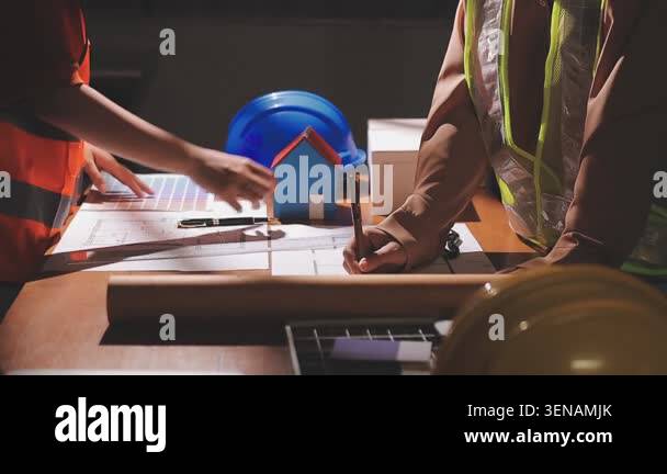 construction engineer or engineer working on blueprints at construction ...