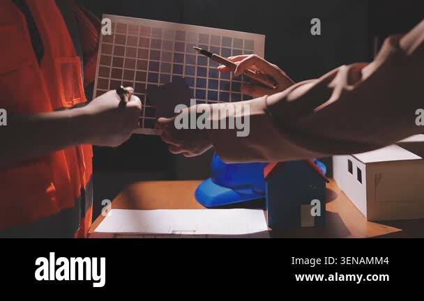 the worker is checking the color of the new house. the concept of the ...