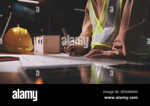 engineer engineer architect working on laptop with blueprint in office ...