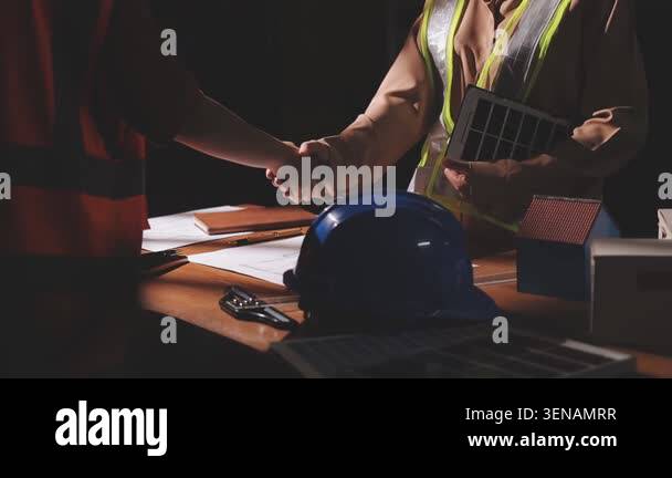 female engineer with protective helmet and protective gloves working ...