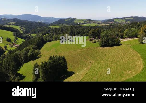 Beautiful aerial footage showing a vast expanse of green rolling hills ...