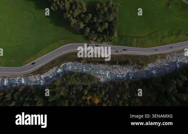 Top down aerial view of cars traveling along a scenic mountain highway ...