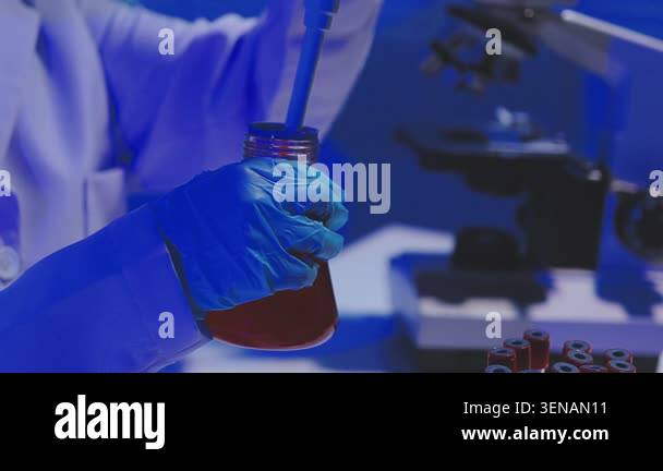 laboratory assistant holds test tube with liquid in hands Stock Video ...