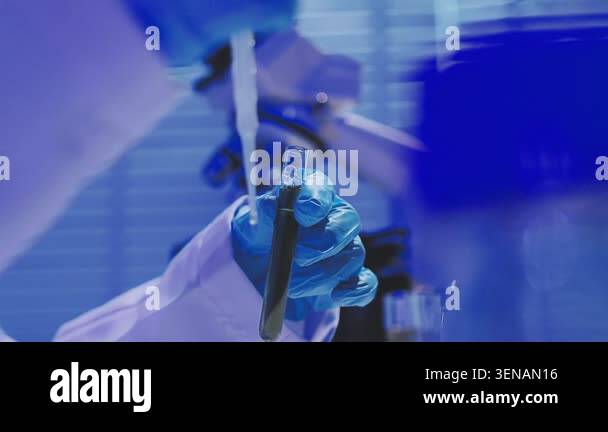 scientist in protective gloves looking at the test tube Stock Video ...