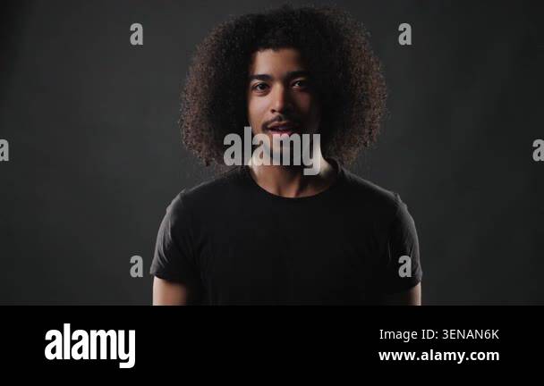 Youthful Expression And Confidence, Young Man With Afro Hair Looking ...