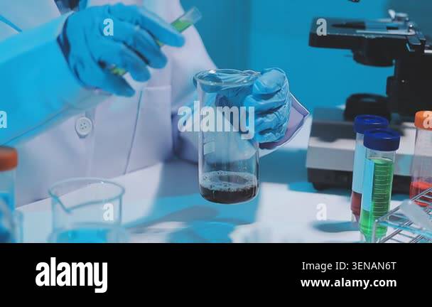 the concept of laboratory and research. a young scientist is looking at ...