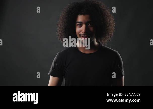 Serious Young African American Man With Curly Hair And Beard In Black T ...