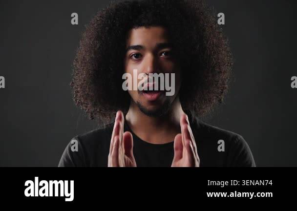 Shocked Young Man With Curly Hair Expressing Surprise And Disbelief ...