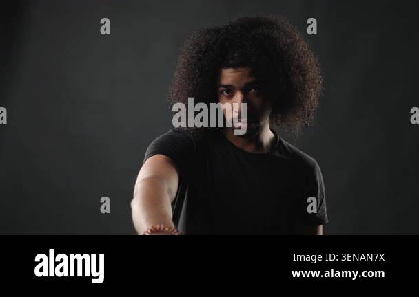 Serious Young Man With Afro Hairstyle And Dark T-Shirt Looking Directly ...