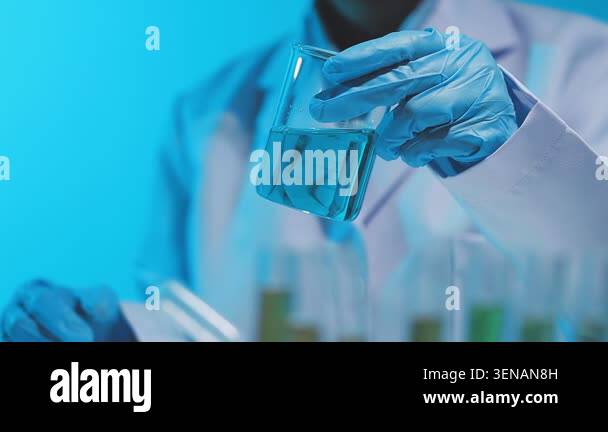 laboratory scientist holding glass tube with chemical liquid in ...