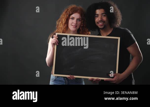 Diverse Couple Holding Blank Chalkboard For Customizable Message ...