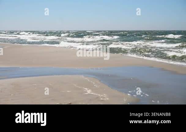 Serene ocean beach scene with soft waves rolling onto smooth sandy ...