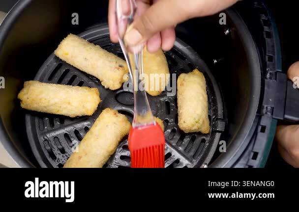 Woman hand holding the red silicon brushing butter wash into the air ...