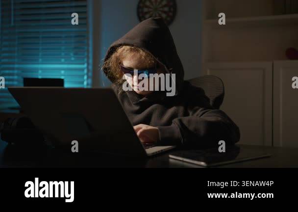 Hacker child in hoodie dark theme. Cyber hacker kid stealing data from ...