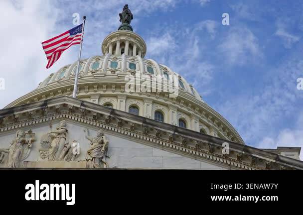 American flag waving on Capitol landmark. American flag in clouds ...