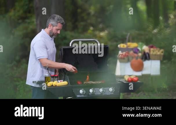 Backyard grill with rest. Man cooking tasty barbeque. Barbeque scene ...