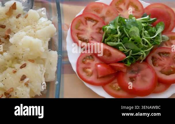 Complete meal is being served with pork ribs, cassava, and tomato salad ...