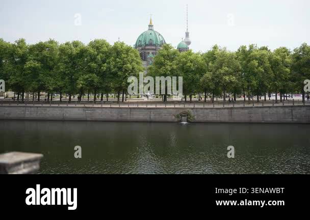 The Spree embankment and leafy linden trees frame the Berlin Cathedral ...