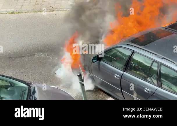 Large orange flames engulf the front of a parked station wagon before ...