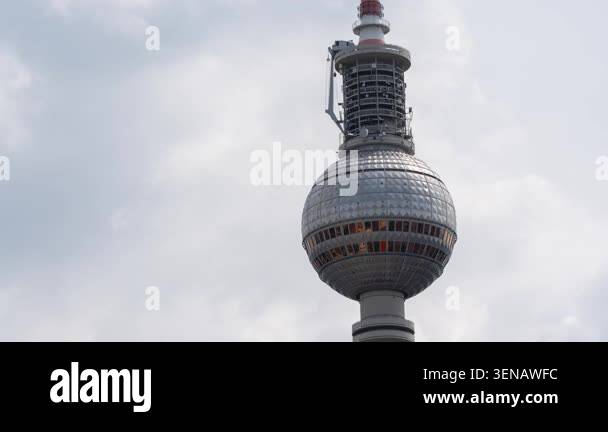 Berlin TV Tower rises against a cloudy sky, showing its silver sphere ...