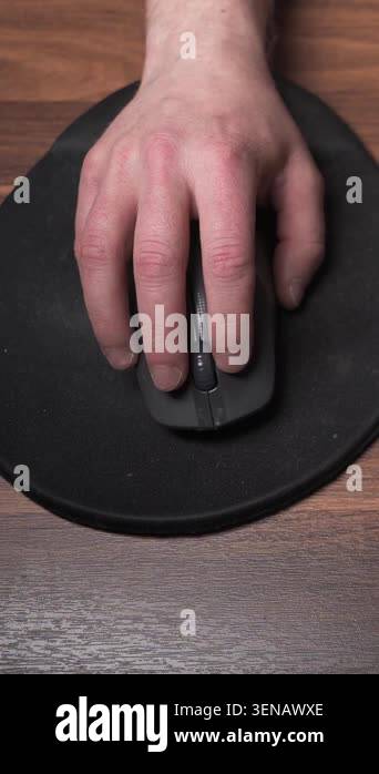 Overhead view of hand using mouse, scrolling wheel and clicking in home ...