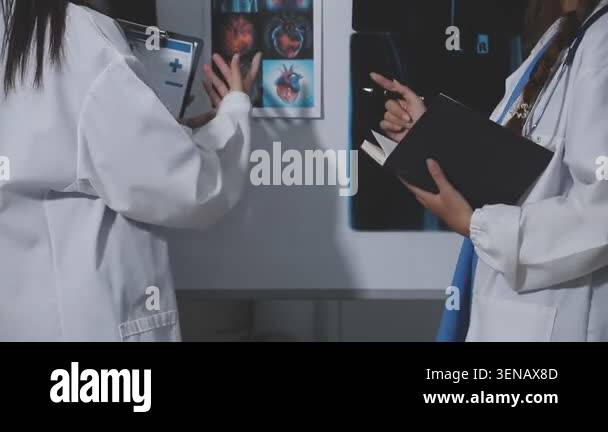 young woman doctor in medical uniform holding x - ray of her patient in ...