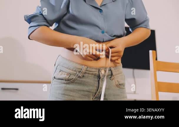 woman with blue jeans and measuring tape on the waist Stock Video ...